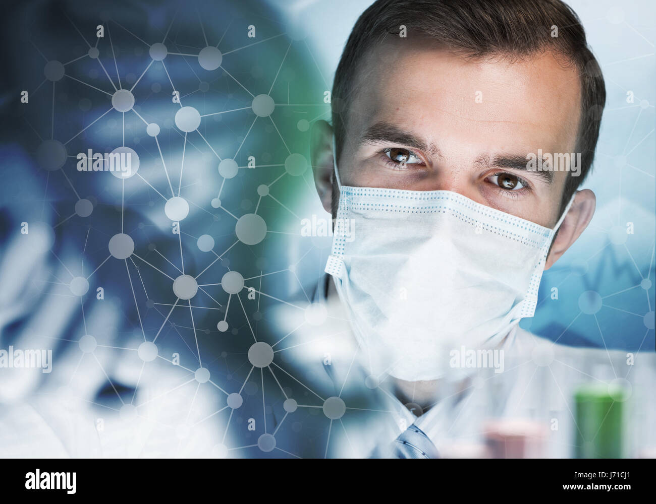 Portrait of concentrated male scientist working with reagents in ...