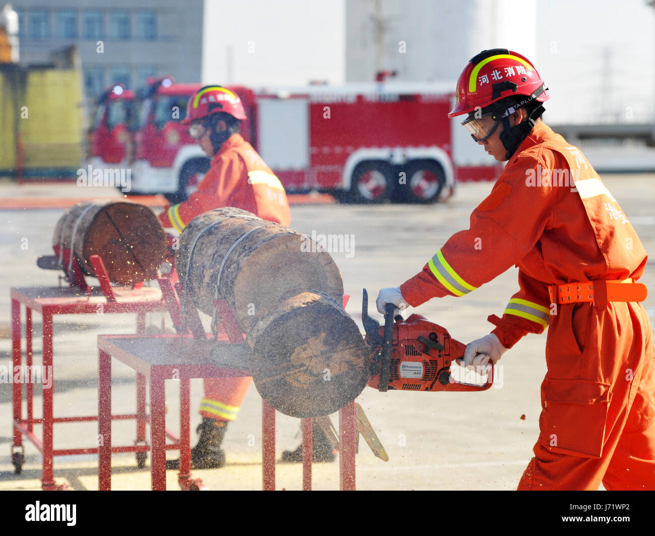 Cangzhou. 23rd May, 2017. Firemen use chain saws to cut wood during a ...