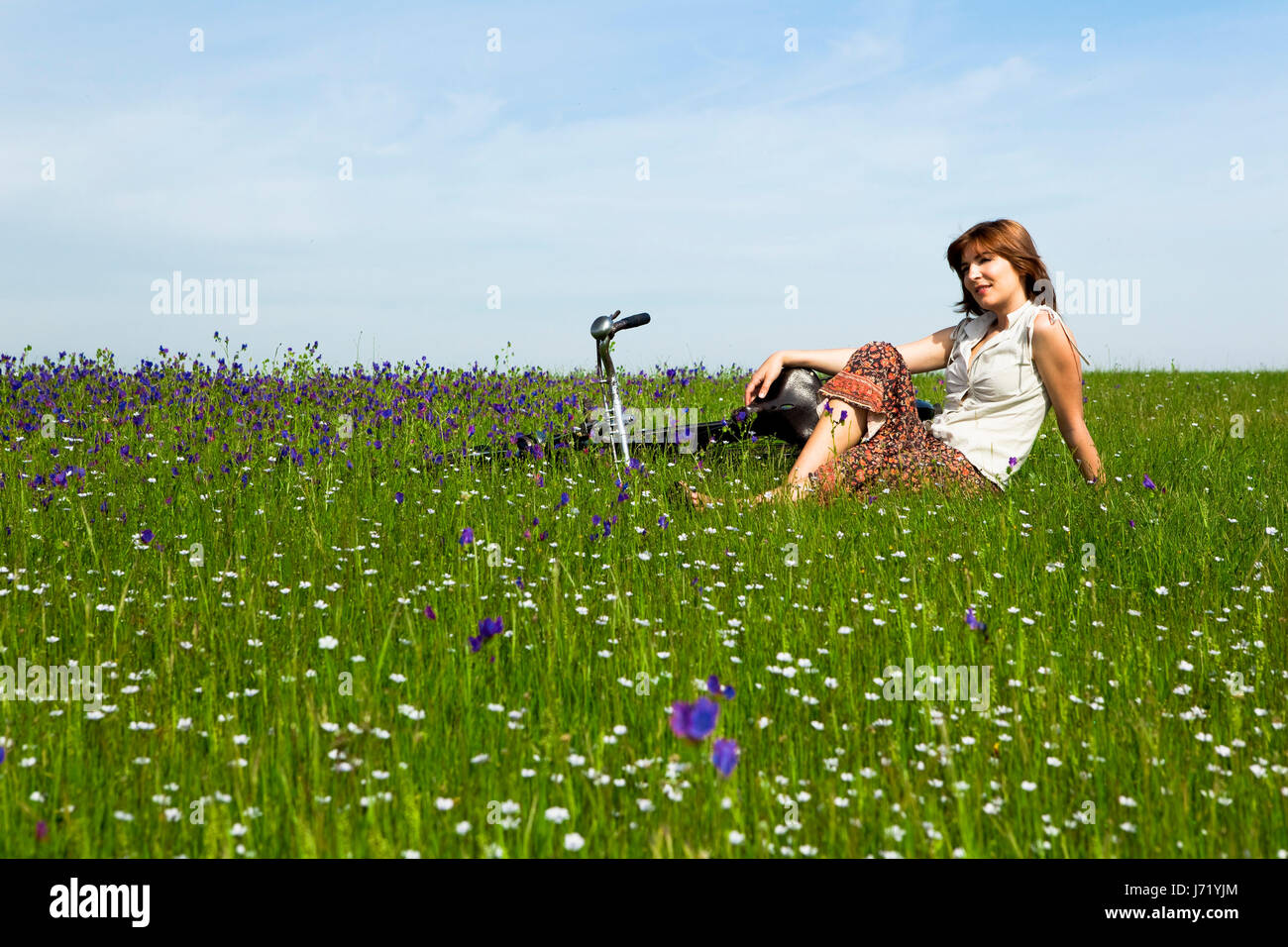 woman field spring bouncing bounces hop skipping frisks jumping jump ...