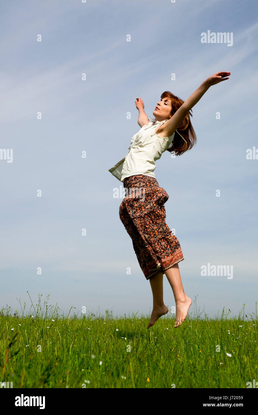 woman field spring bouncing bounces hop skipping frisks jumping jump ...
