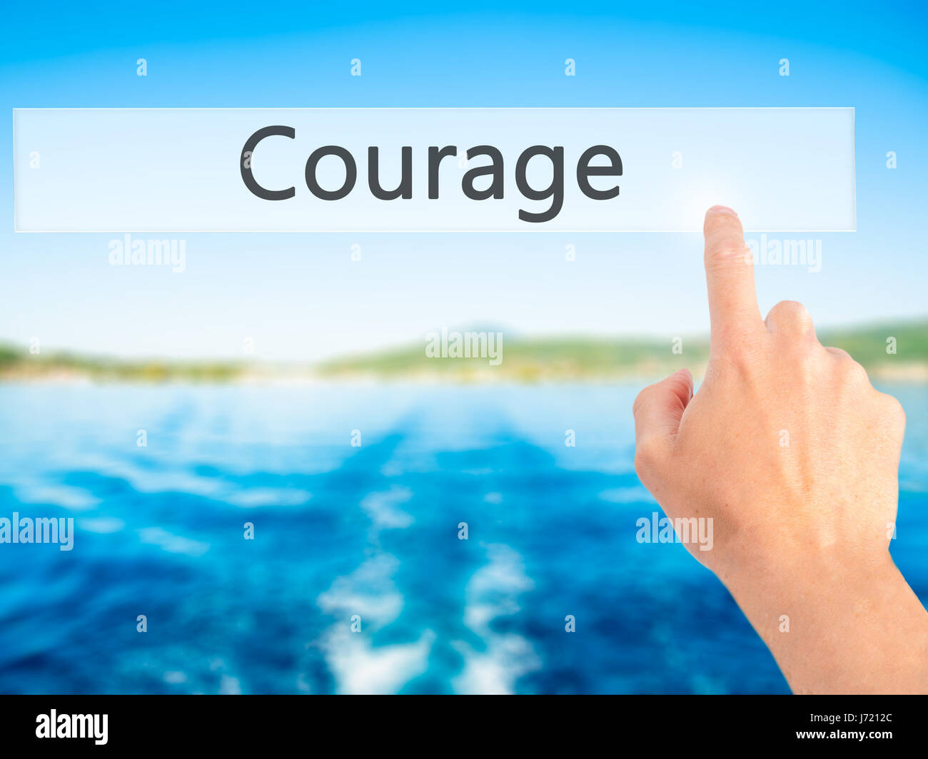Courage - Hand pressing a button on blurred background concept ...