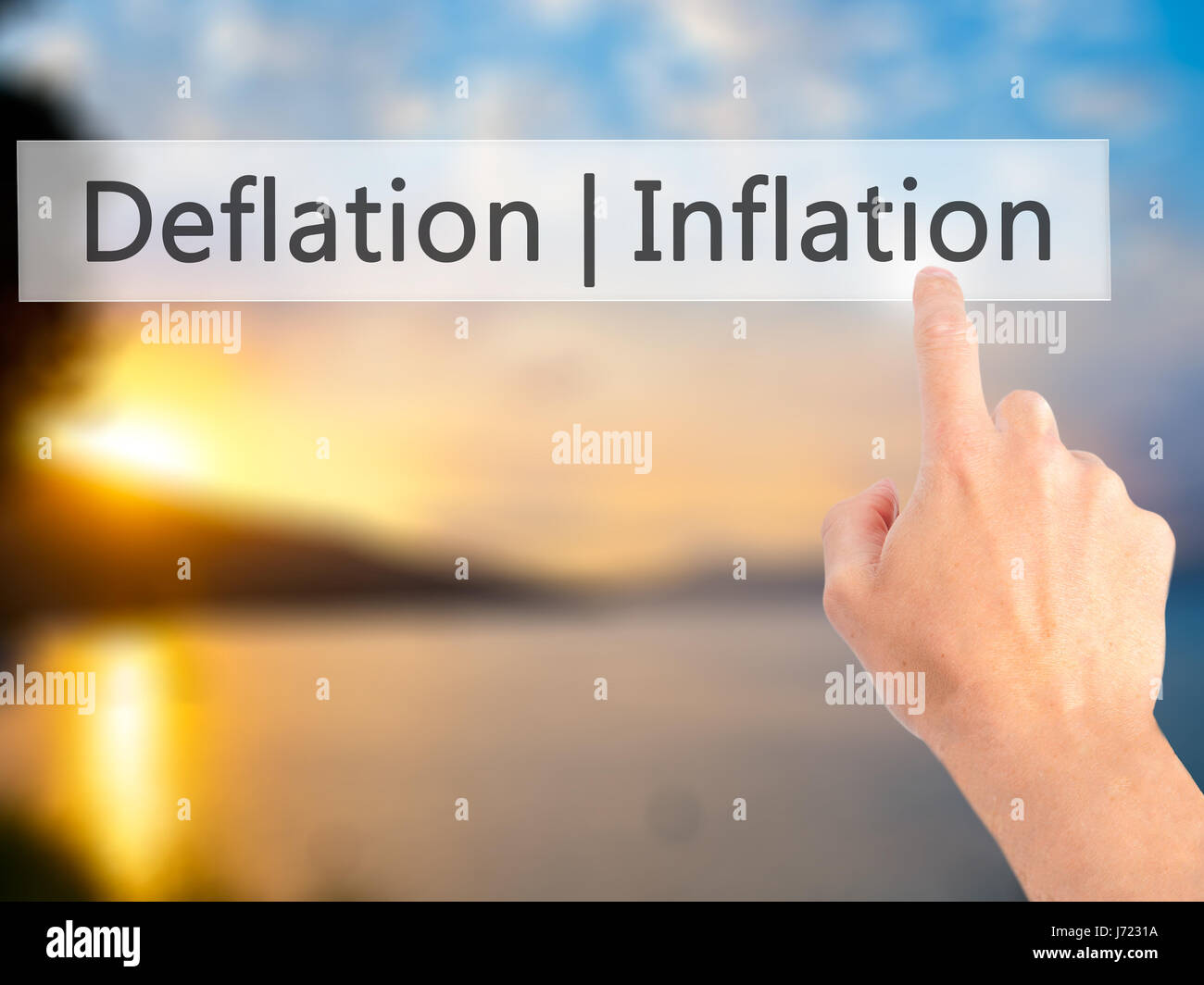 Deflation Inflation - Hand pressing a button on blurred background ...