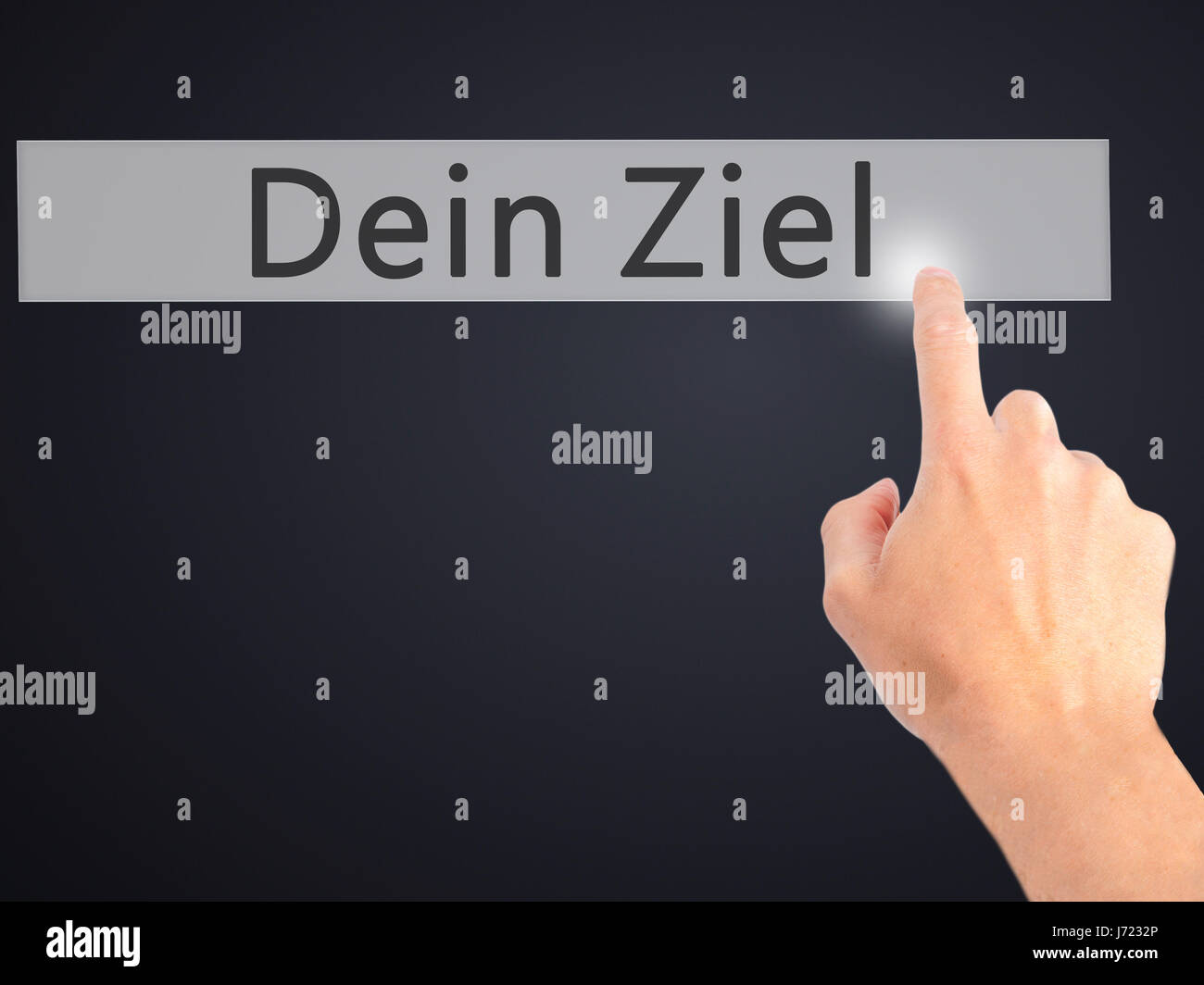 Dein Ziel (Your Goal in German) - Hand pressing a button on blurred ...