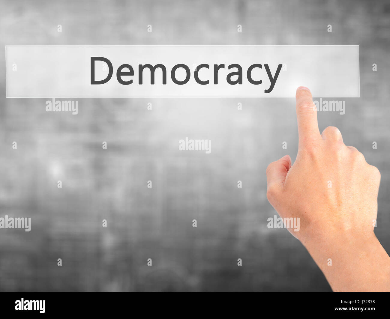Democracy - Hand pressing a button on blurred background concept ...