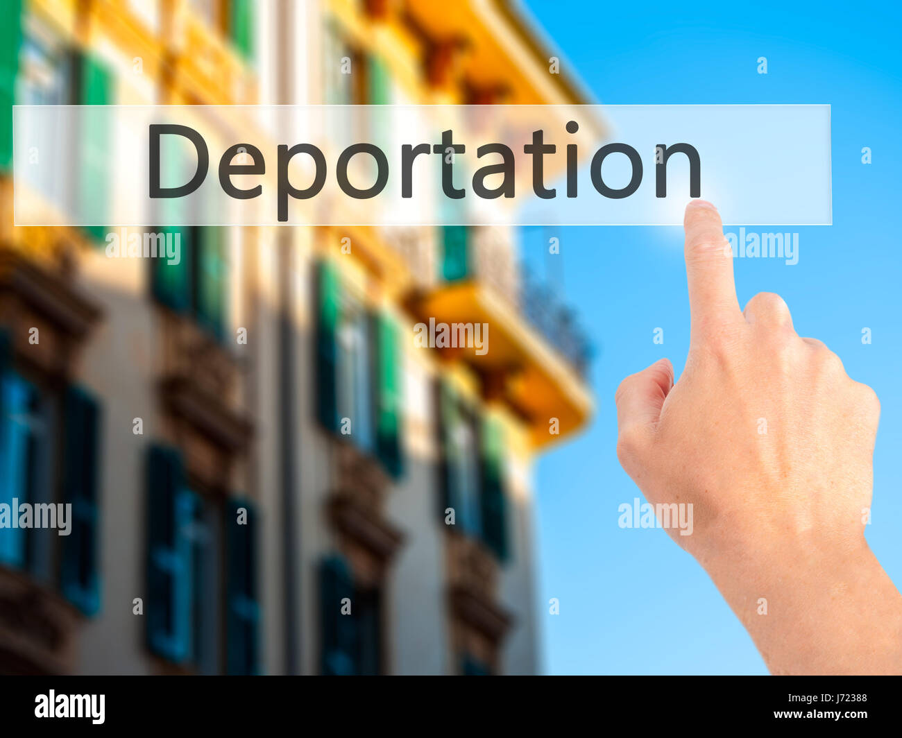 Deportation - Hand pressing a button on blurred background concept ...