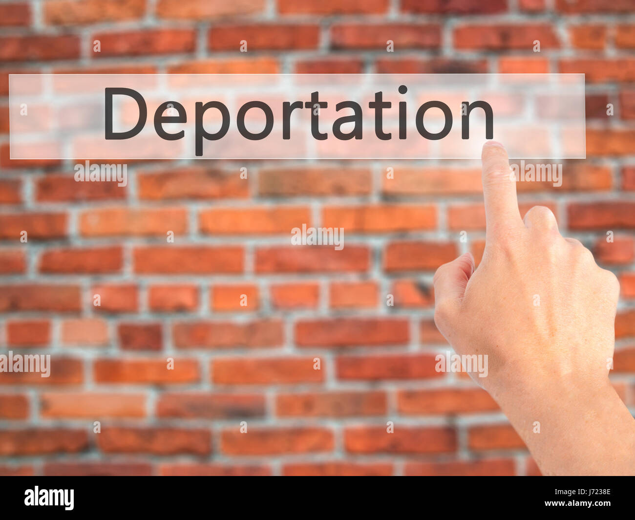 Deportation - Hand pressing a button on blurred background concept ...
