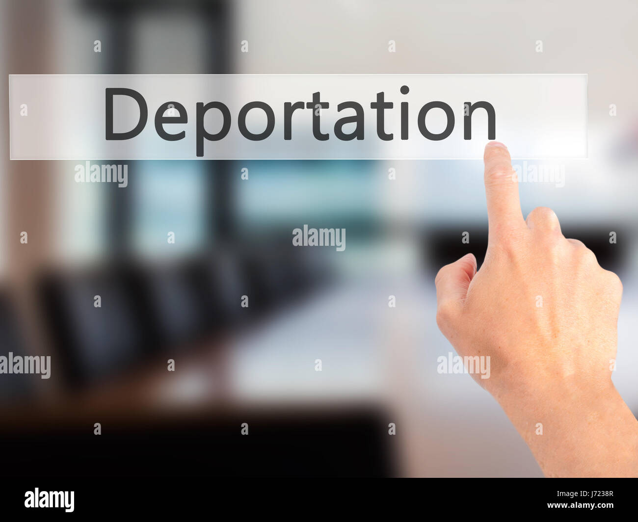 Deportation - Hand pressing a button on blurred background concept ...
