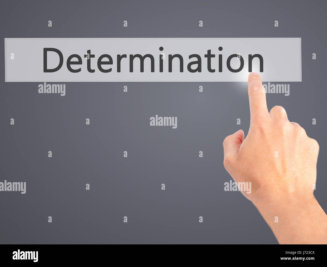 Determination - Hand pressing a button on blurred background concept ...