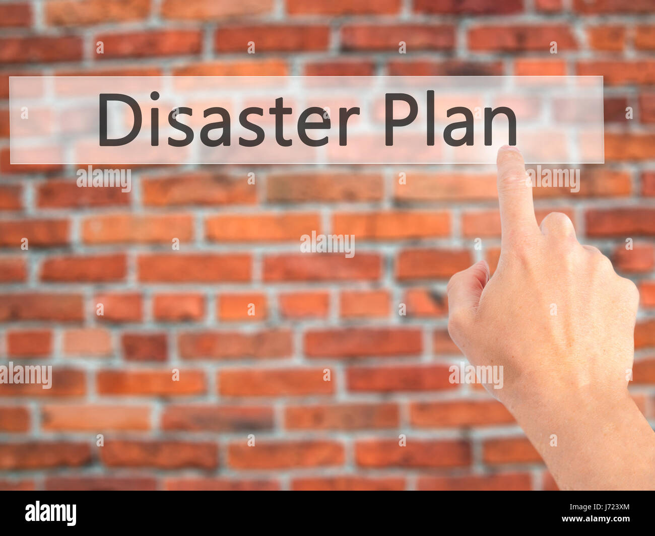 Disaster Plan - Hand pressing a button on blurred background concept ...