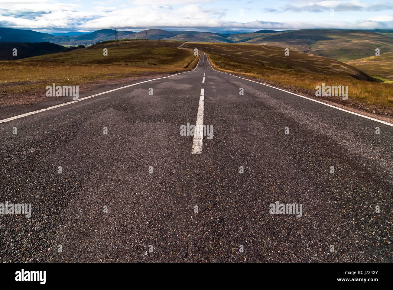 asphalt road leads into the distance v2 Stock Photo - Alamy