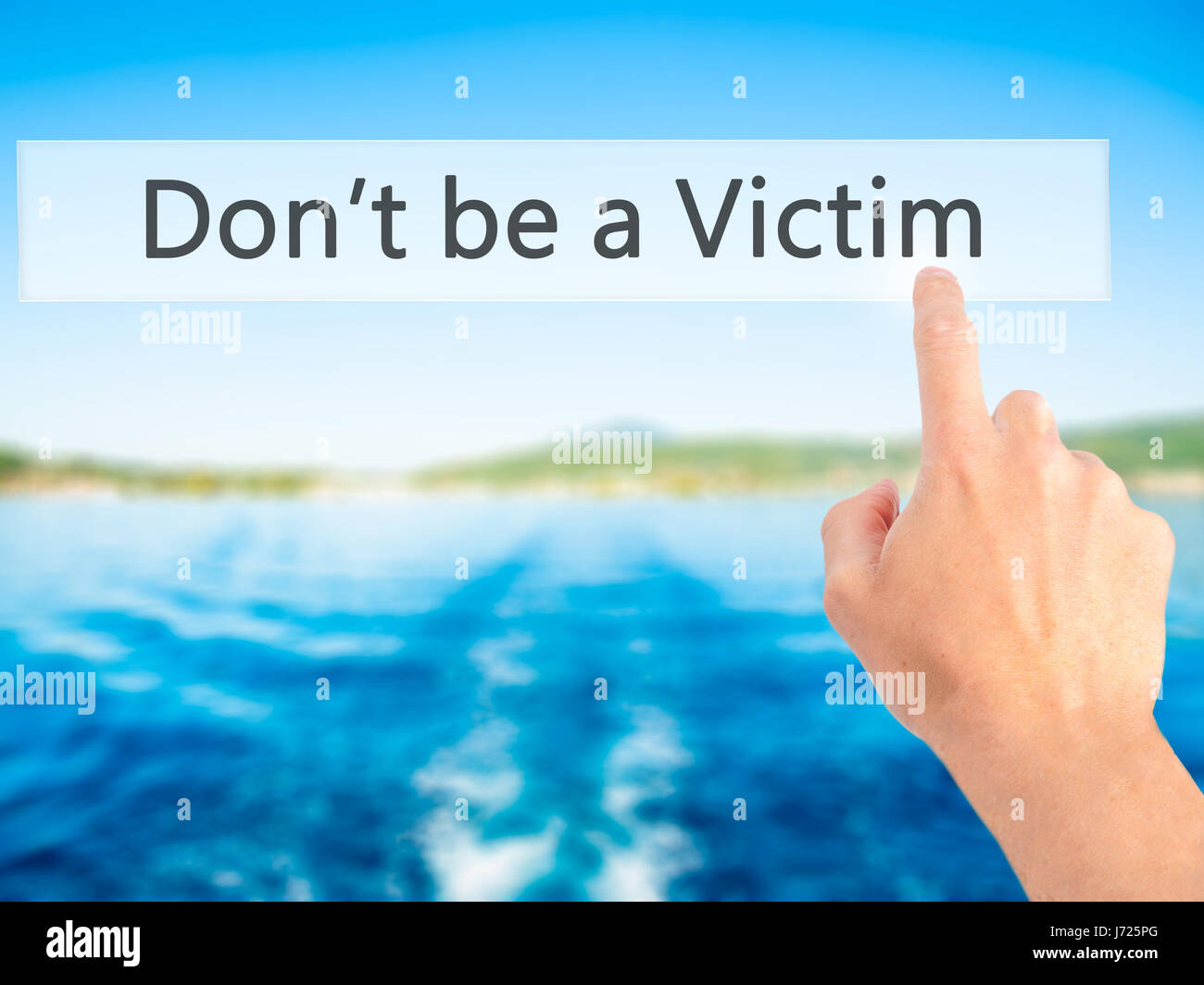 Don't be a Victim - Hand pressing a button on blurred background ...