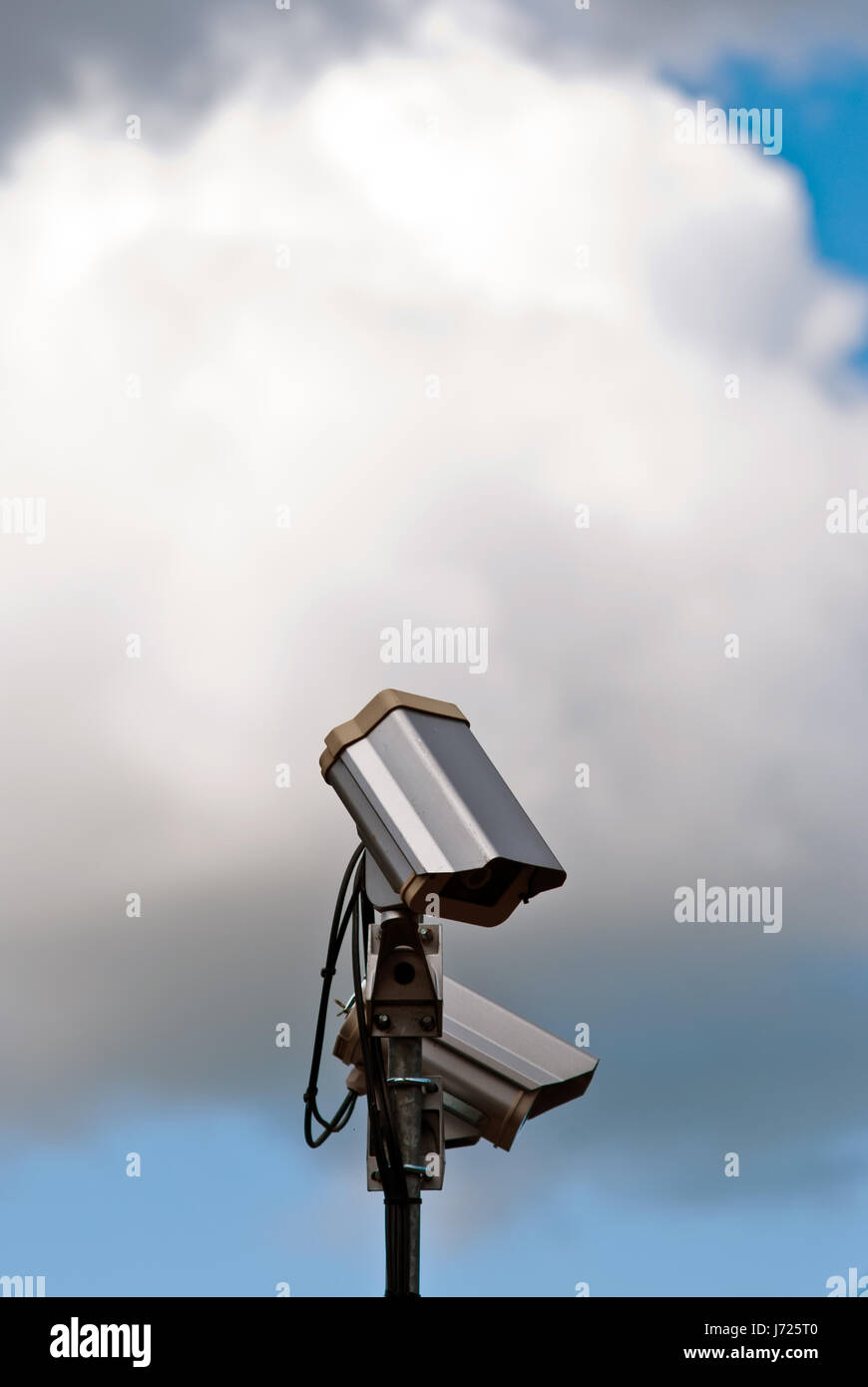 surveillance camera against sky v1 Stock Photo - Alamy