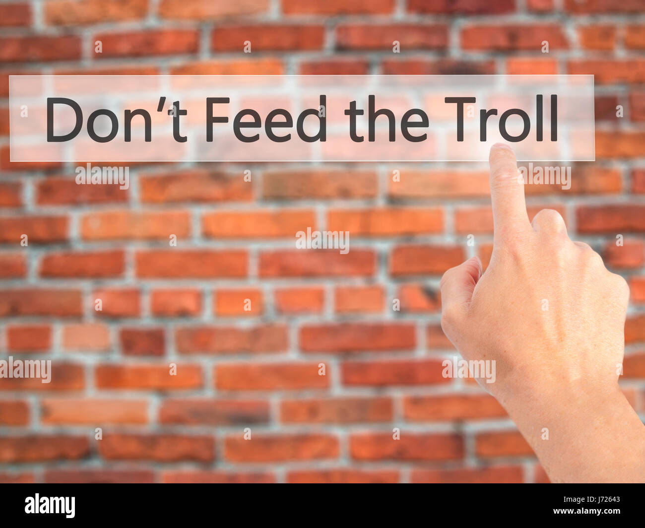 Don't Feed the Troll - Hand pressing a button on blurred background ...