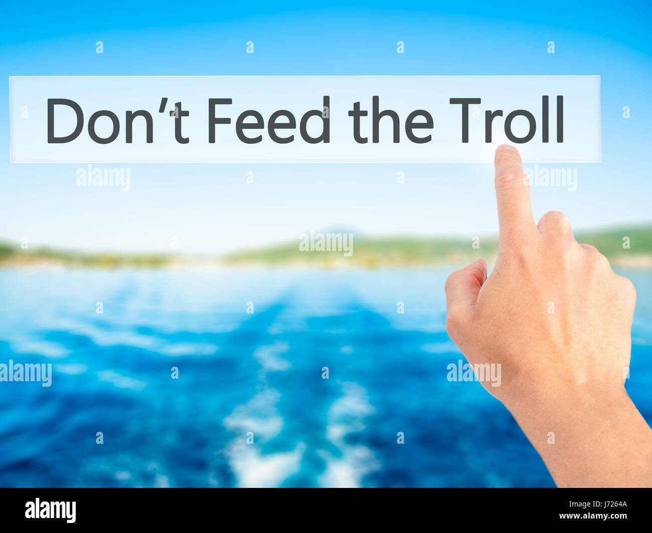 Don't Feed the Troll - Hand pressing a button on blurred background ...