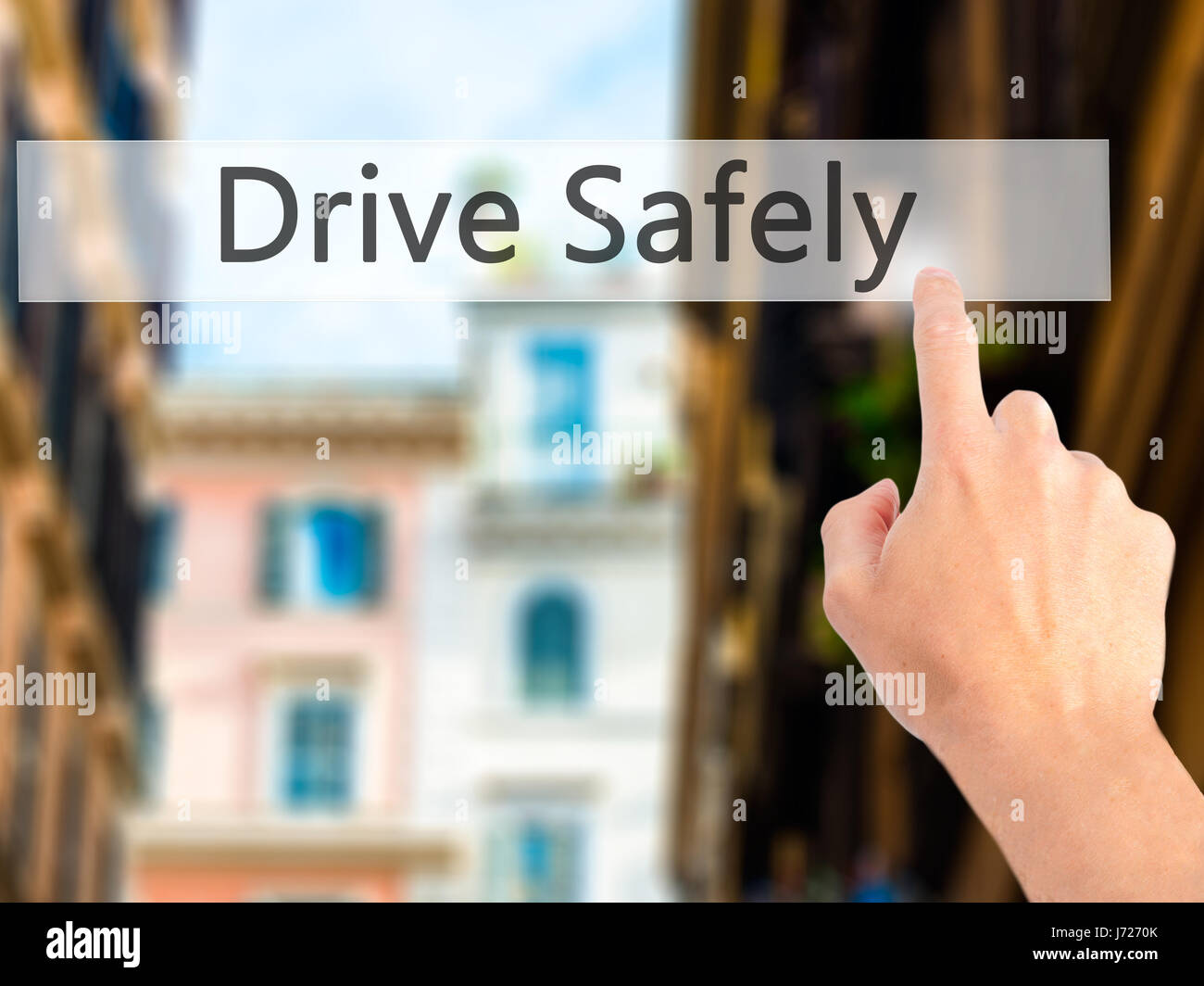 Drive Safely - Hand pressing a button on blurred background concept ...