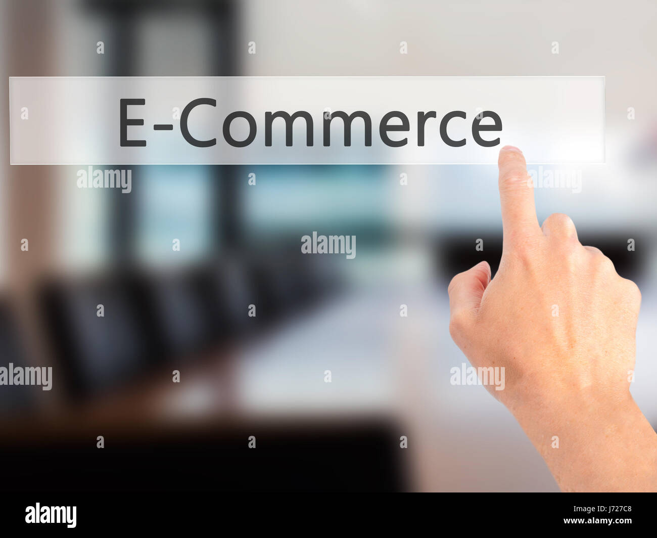 E-Commerce - Hand pressing a button on blurred background concept ...