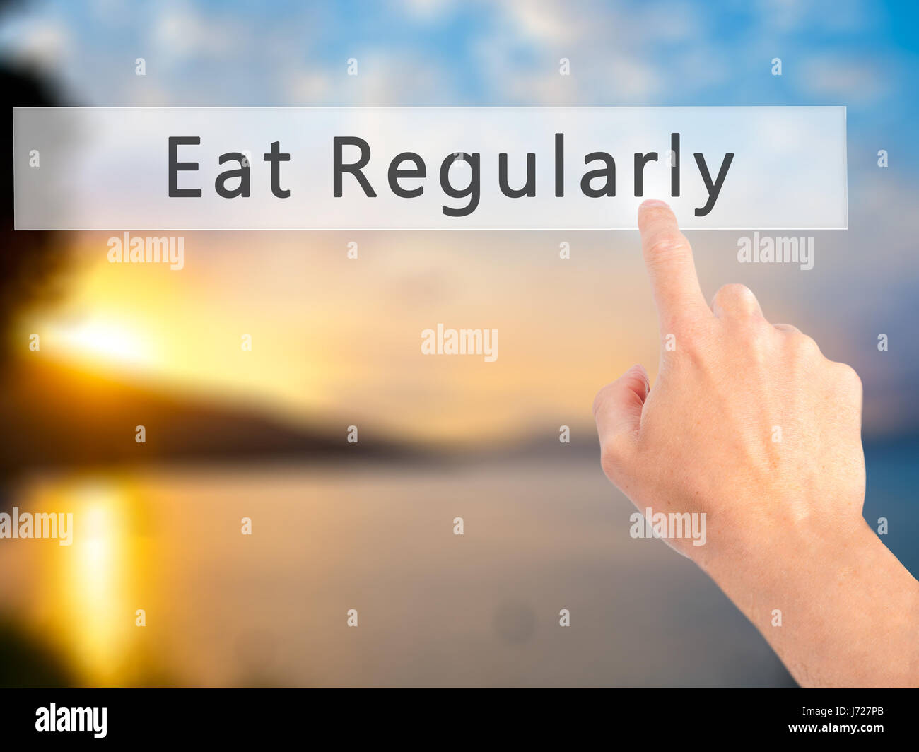 Eat Regularly - Hand pressing a button on blurred background concept ...