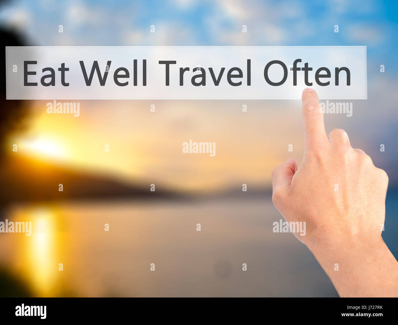 Eat Well Travel Often - Hand pressing a button on blurred background ...