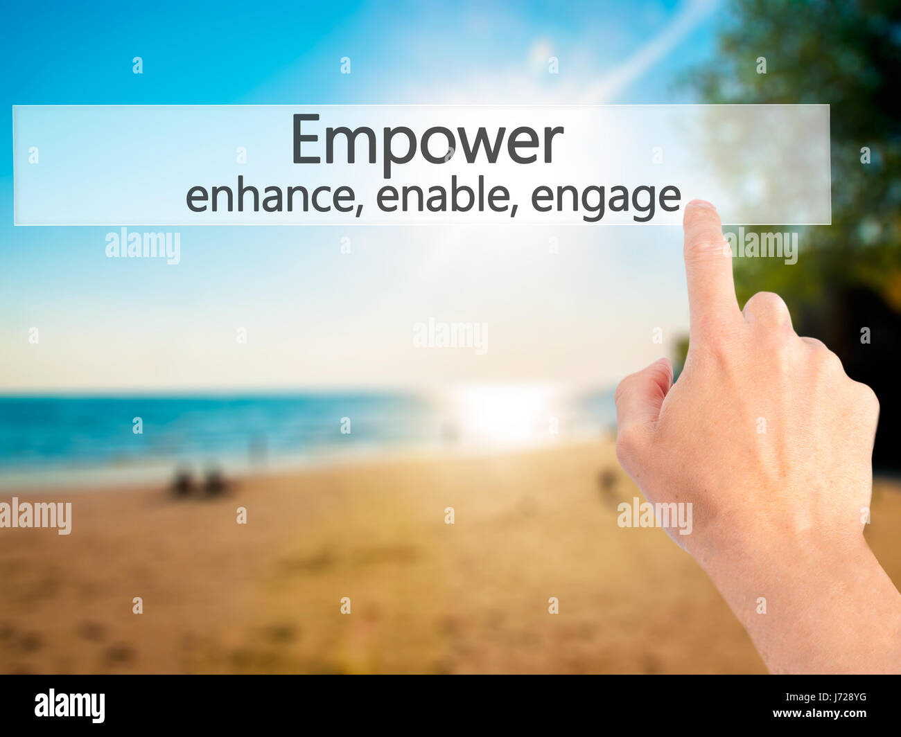 Empower enhance, enable, engage - Hand pressing a button on blurred ...