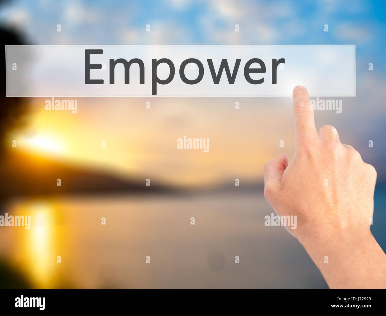 Empower - Hand pressing a button on blurred background concept ...