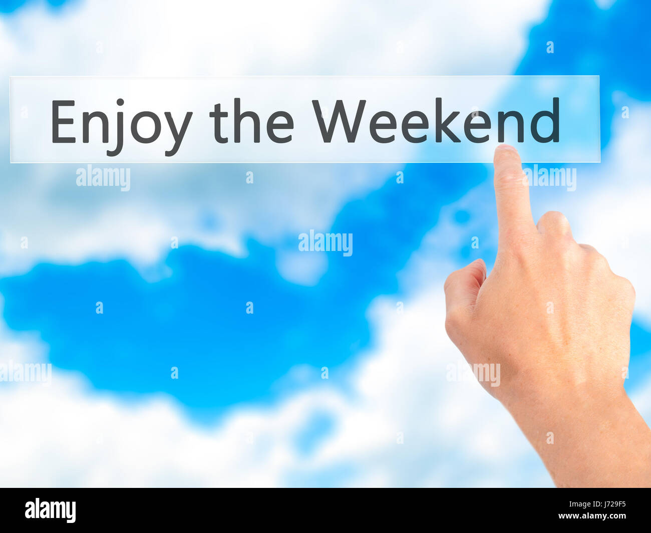 Enjoy the Weekend - Hand pressing a button on blurred background ...
