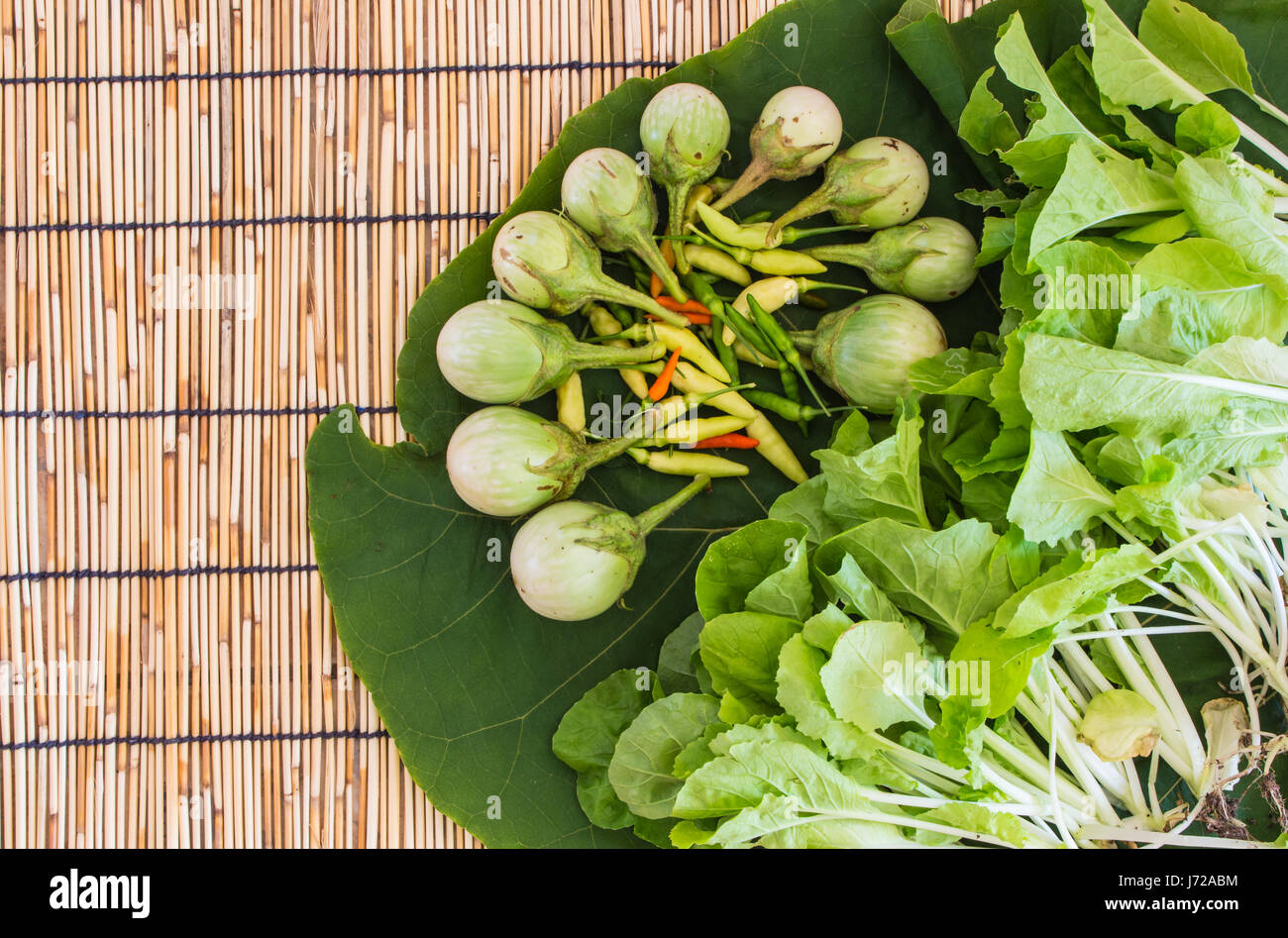 true vegetable on leaf and bamboo blind floor Stock Photo - Alamy