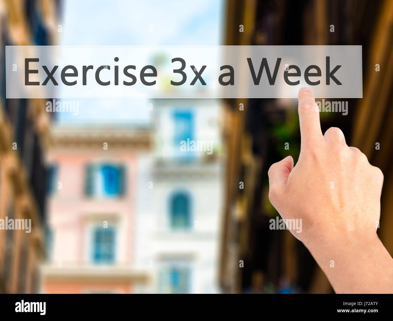 Exercise 3x a Week - Hand pressing a button on blurred background ...
