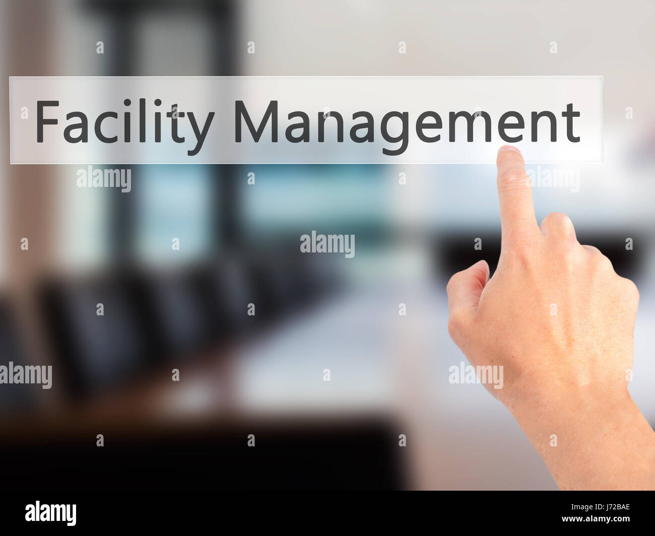 Facility Management - Hand pressing a button on blurred background ...