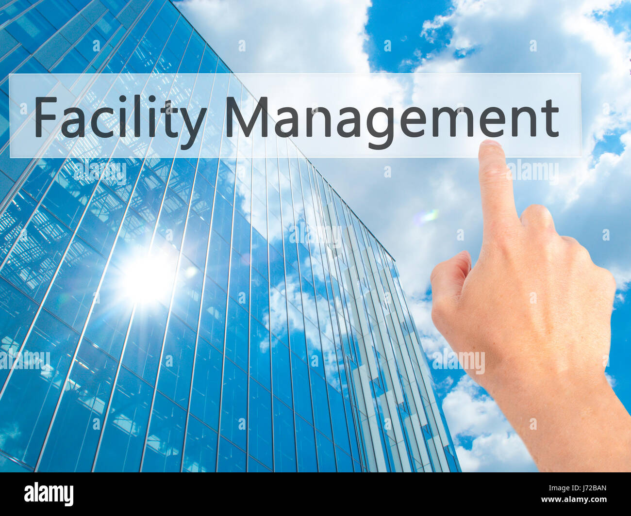 Facility Management - Hand pressing a button on blurred background ...