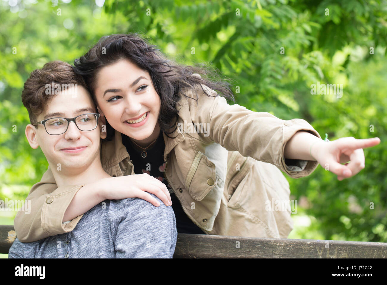 Two young smiling teenagers, boyfriend and girlfriend, talk and have ...