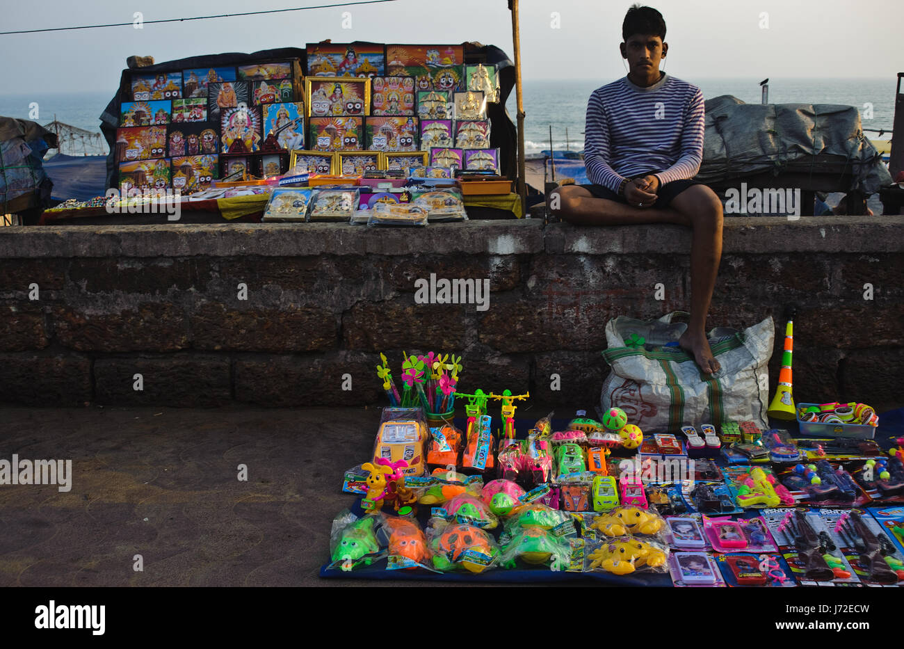 Young man selling plastic toys and souvenirs ( India Stock Photo - Alamy