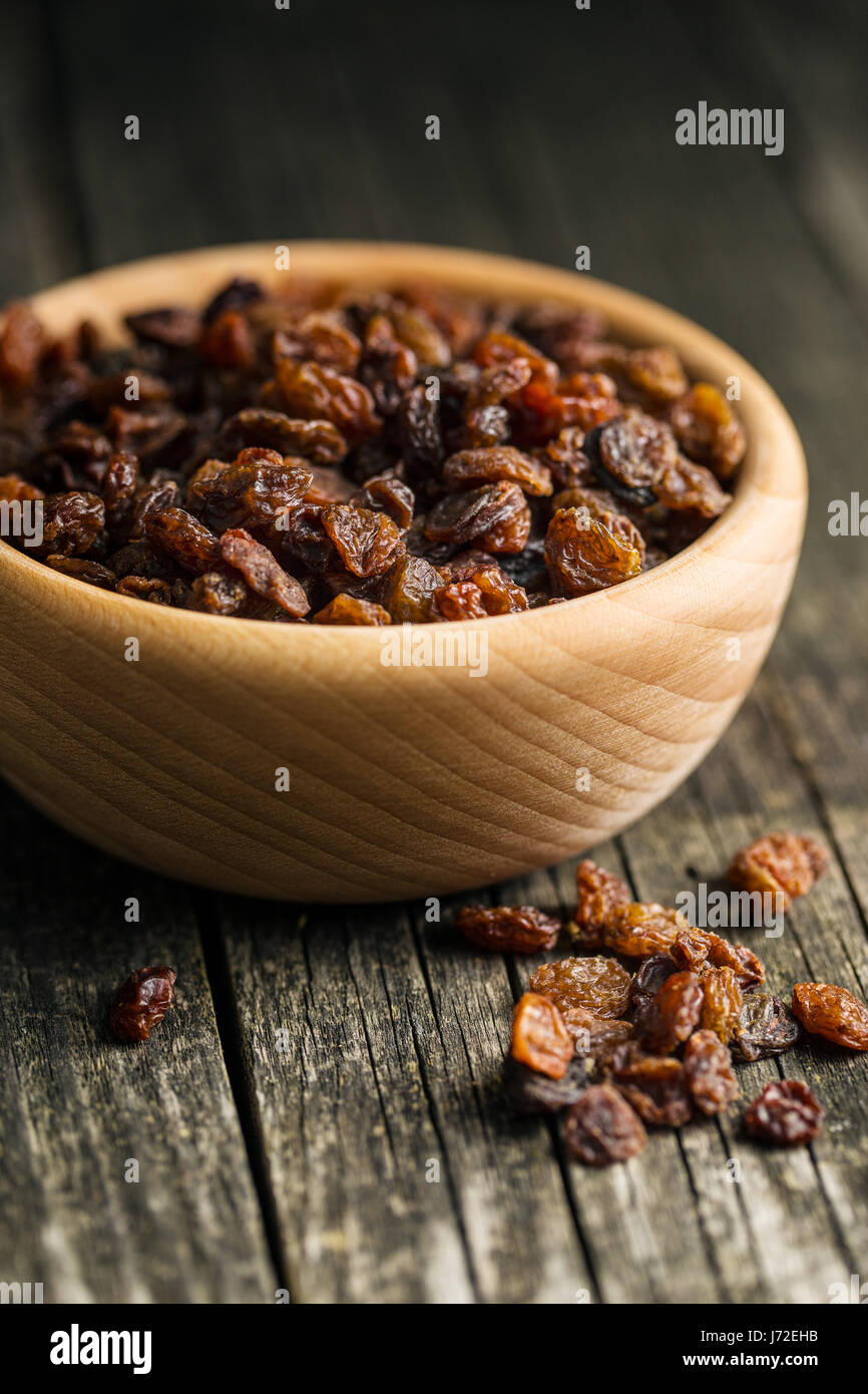 Sweet dried raisins in bowl Stock Photo - Alamy