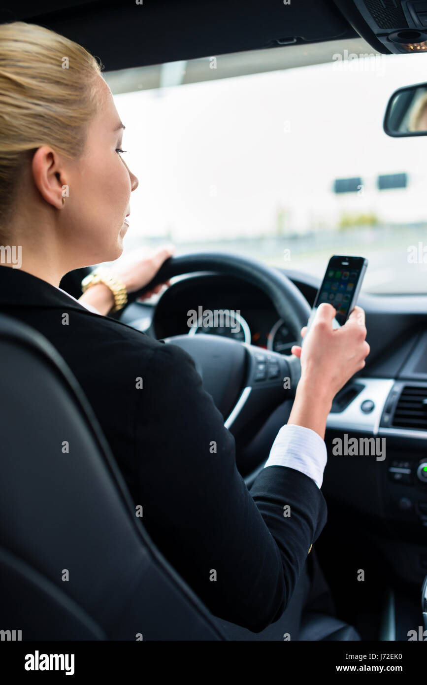woman texting while driving by car Stock Photo - Alamy