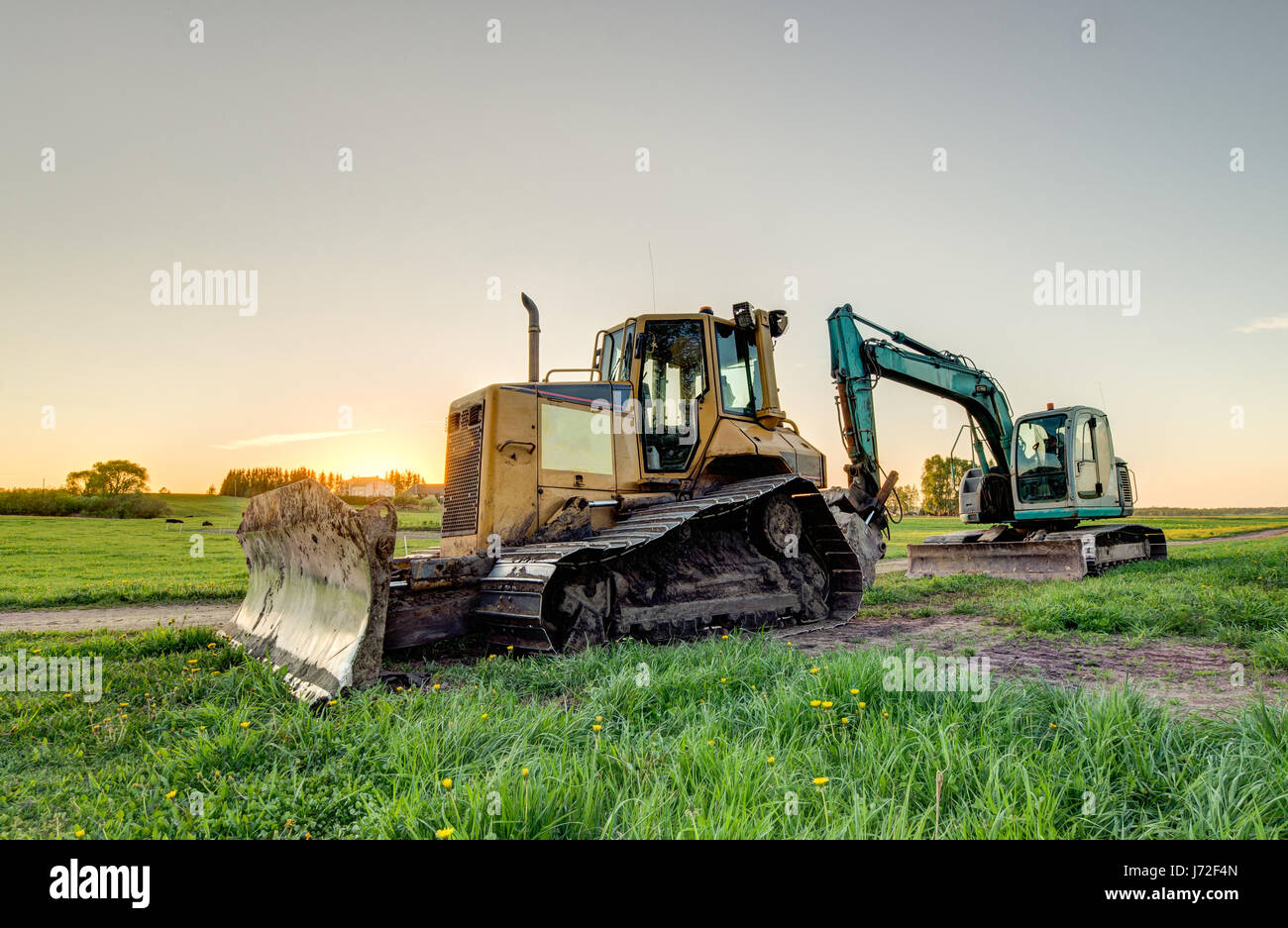 The excavator and bulldozer stayed in the field after work Stock Photo ...