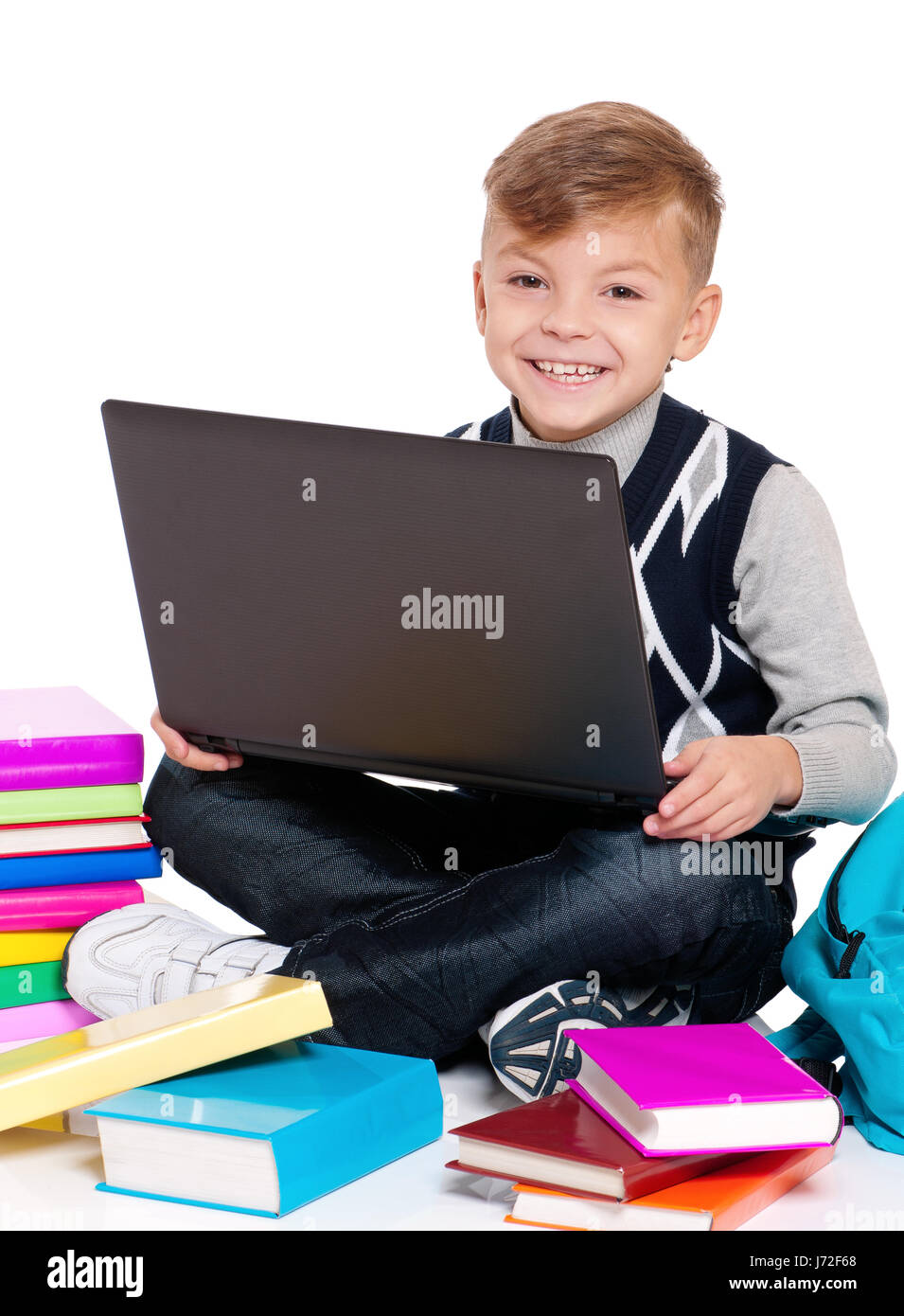 Boy with laptop and books Stock Photo - Alamy