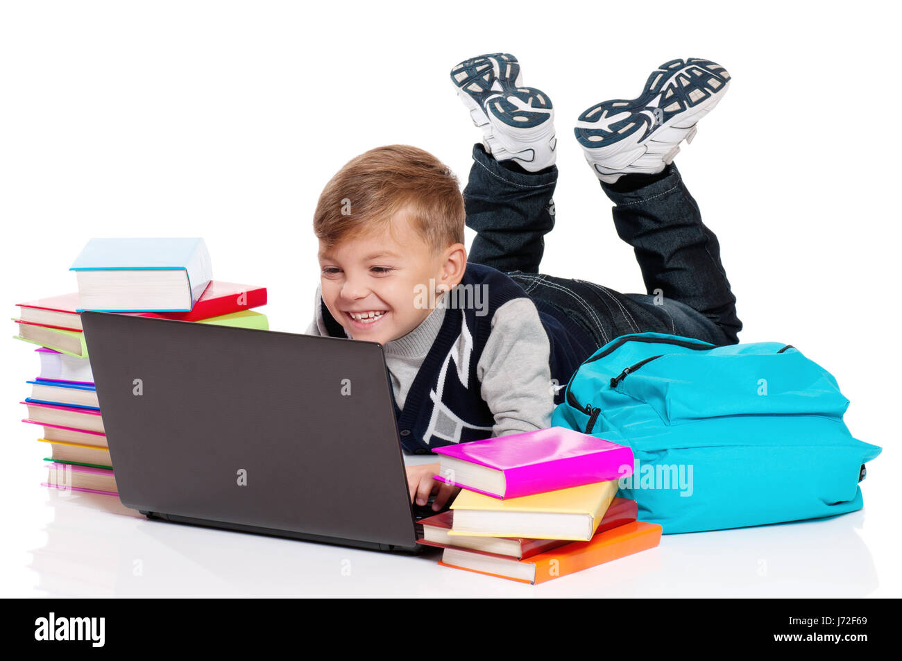 Boy with laptop and books Stock Photo - Alamy