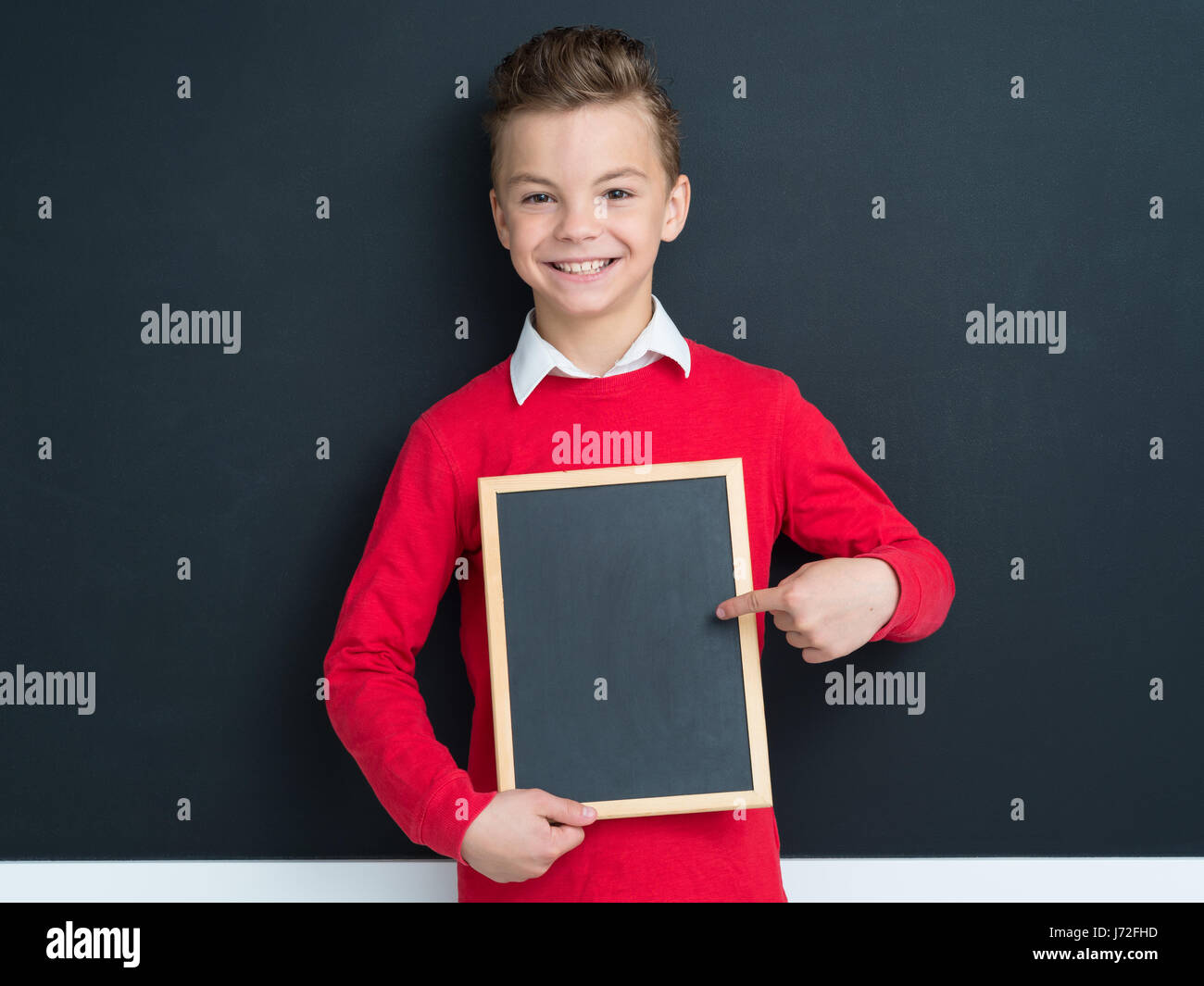 Teen boy with small blackboard Stock Photo - Alamy