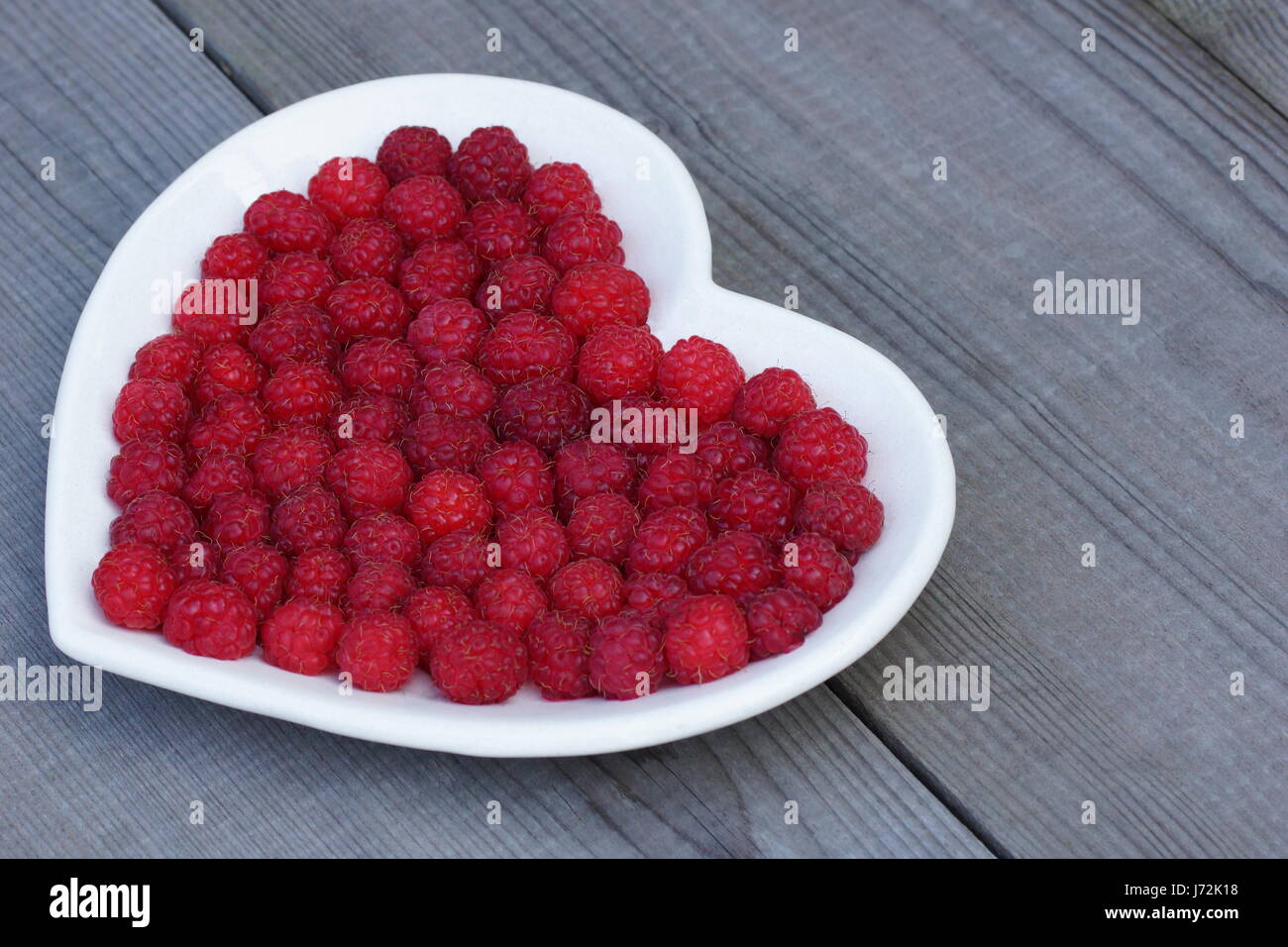 Red heart made of raspberry Stock Photo - Alamy