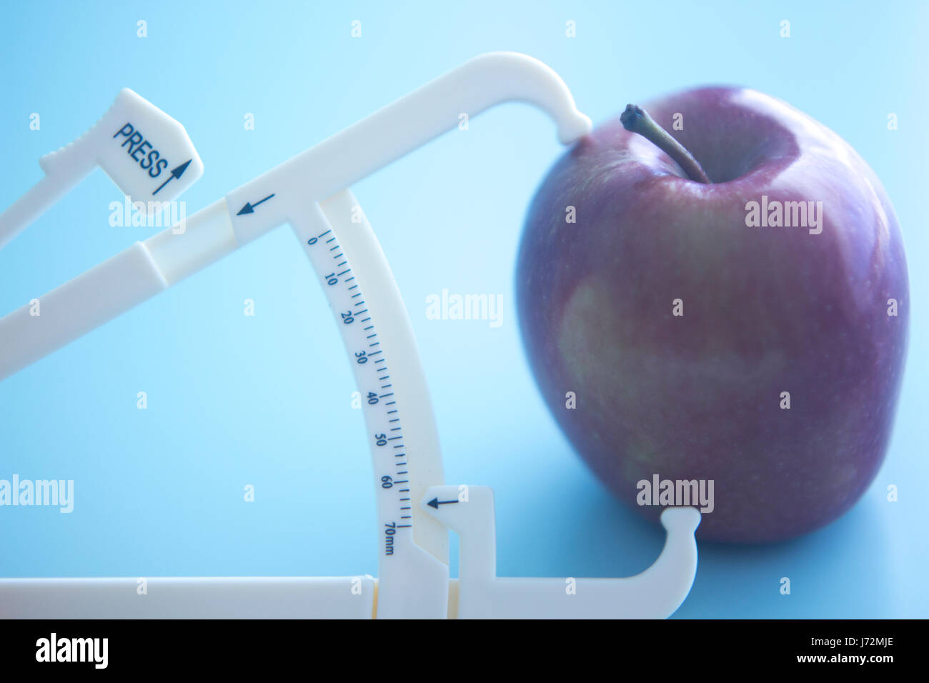 Fat caliper and measuring tape used to measure waistline, bodyfat ...