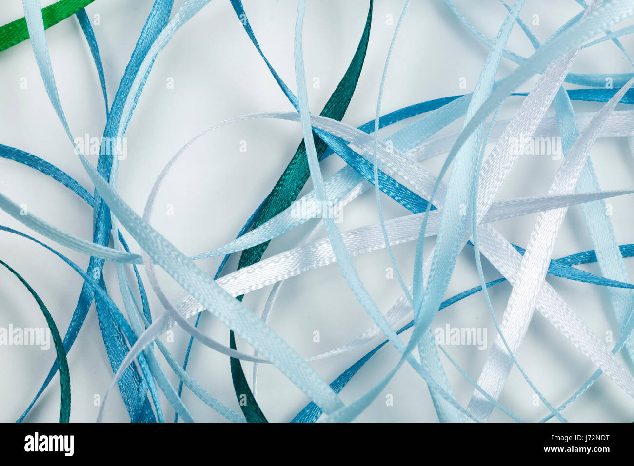 Macro, studio shot of silk ribbons on white background Stock Photo - Alamy