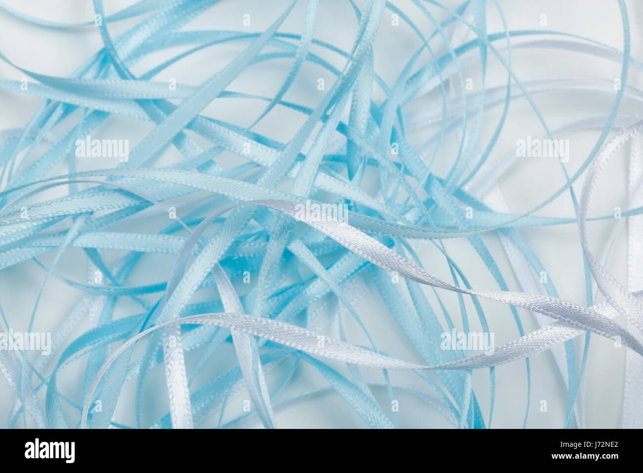 Macro, studio shot of silk ribbons on white background Stock Photo - Alamy