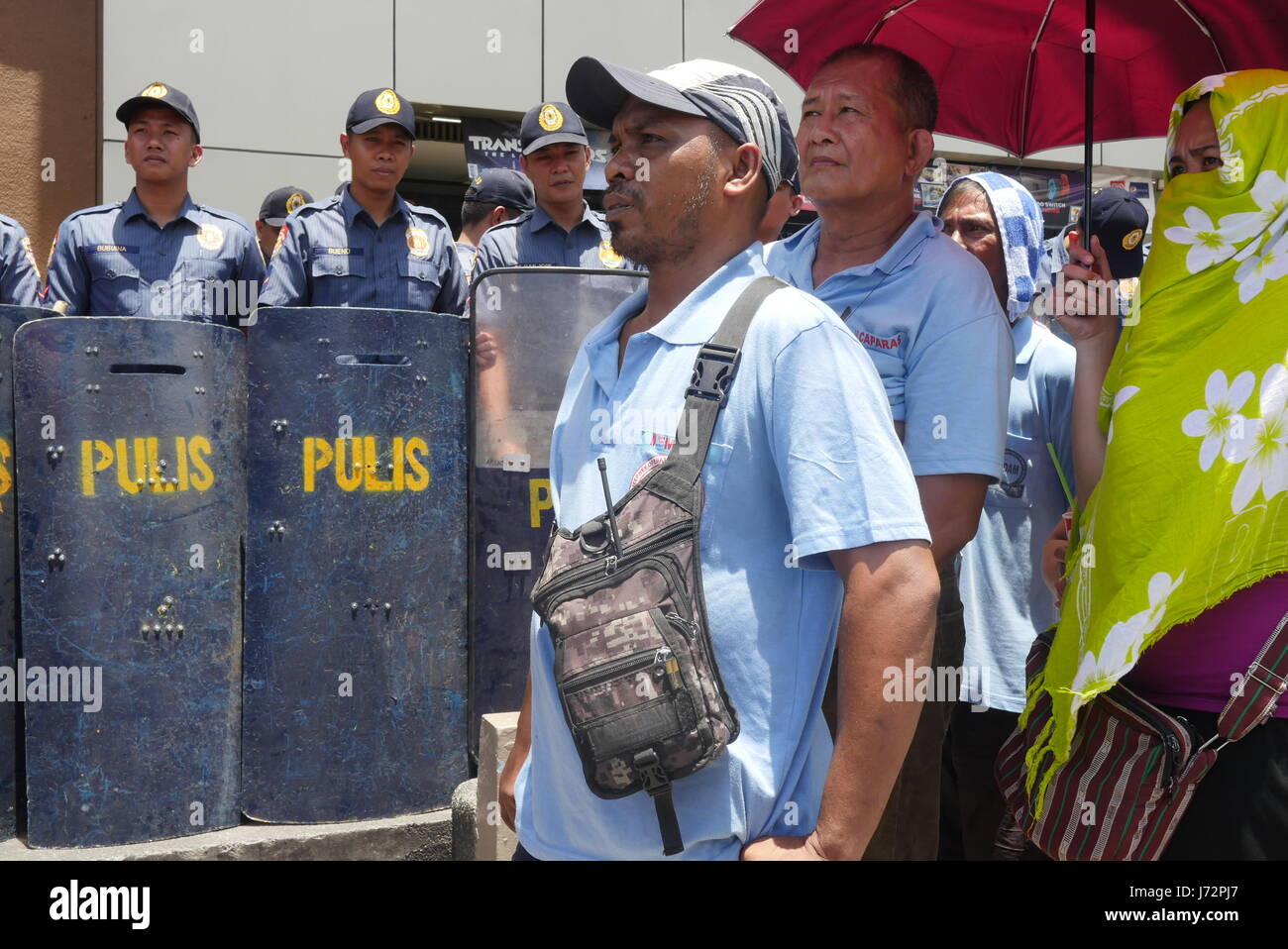 Police officers ready with their shields as jeepney protesters listens ...