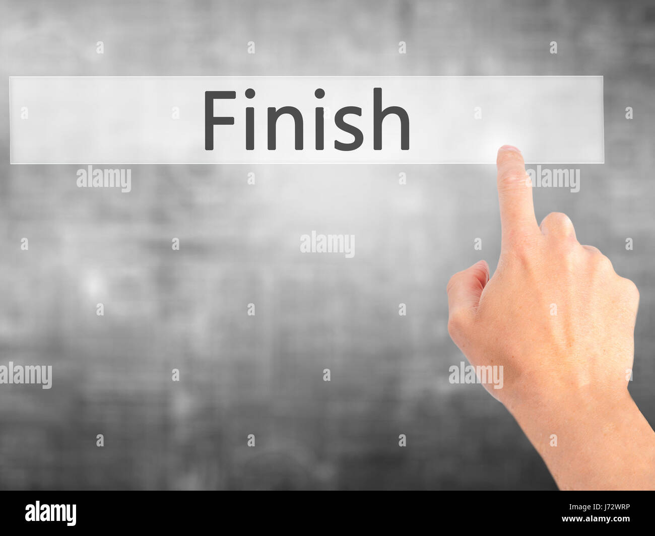 Finish - Hand pressing a button on blurred background concept ...
