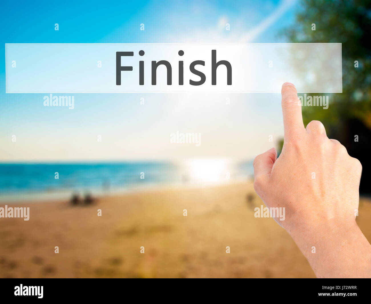 Finish - Hand pressing a button on blurred background concept ...