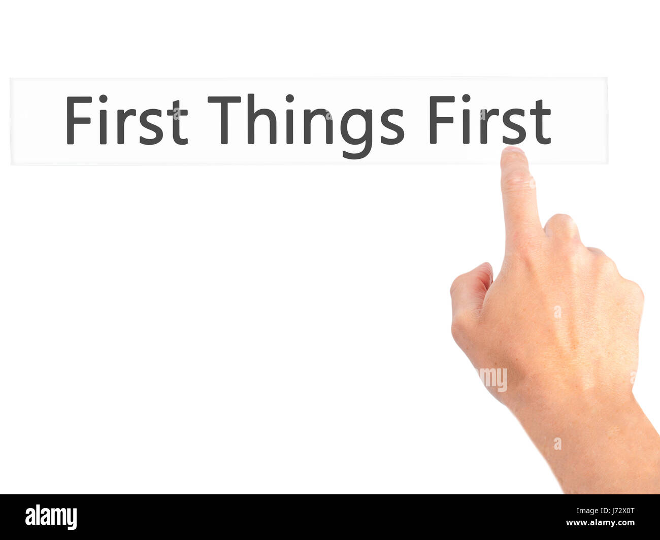 First Things First - Hand pressing a button on blurred background ...