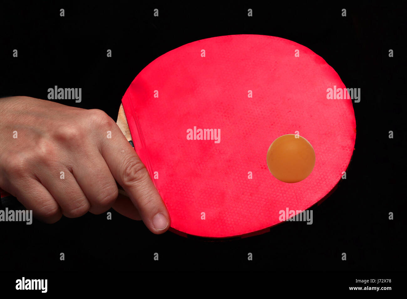 Using the right hand held forehand in shake hand style to hit orange ...