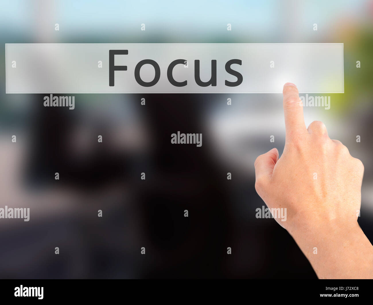 Focus - Hand pressing a button on blurred background concept . Business ...