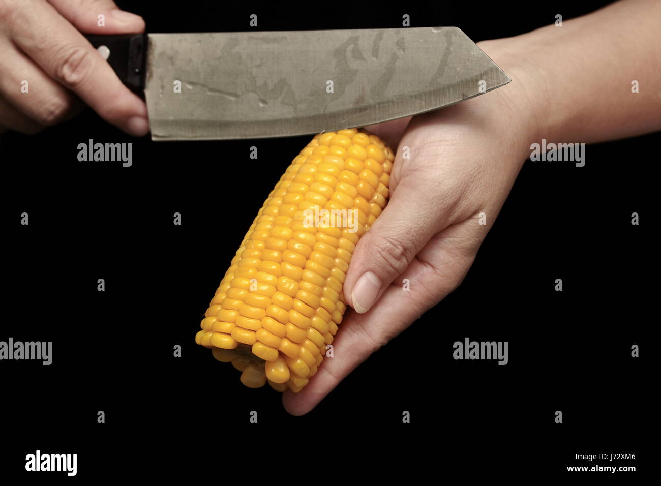 Delicious streamed sweet corn,which is going to be sliced by chef on ...