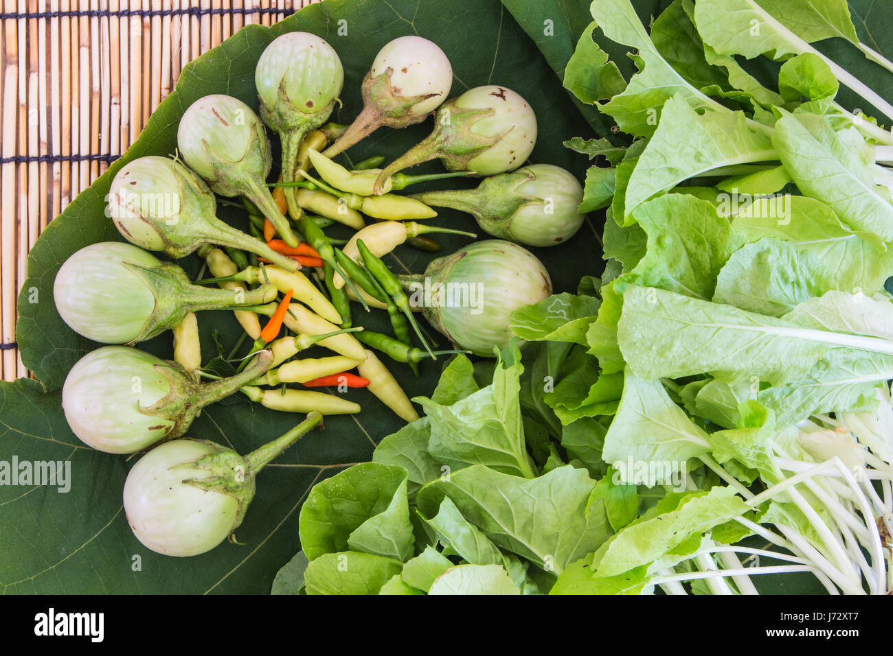 true vegetable on leaf and bamboo blind floor Stock Photo - Alamy