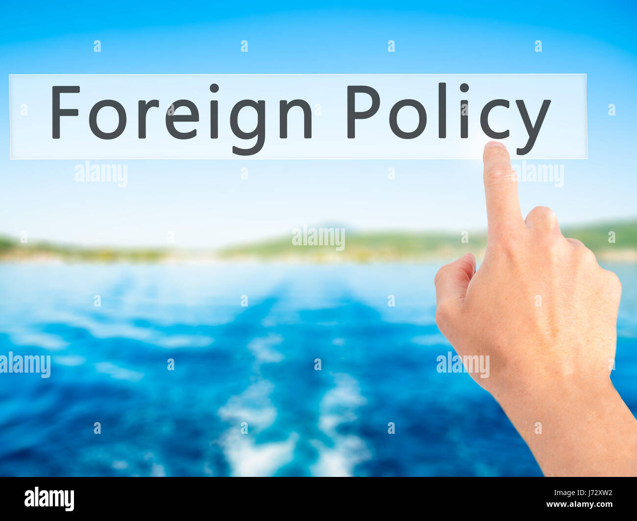 Foreign Policy - Hand pressing a button on blurred background concept ...